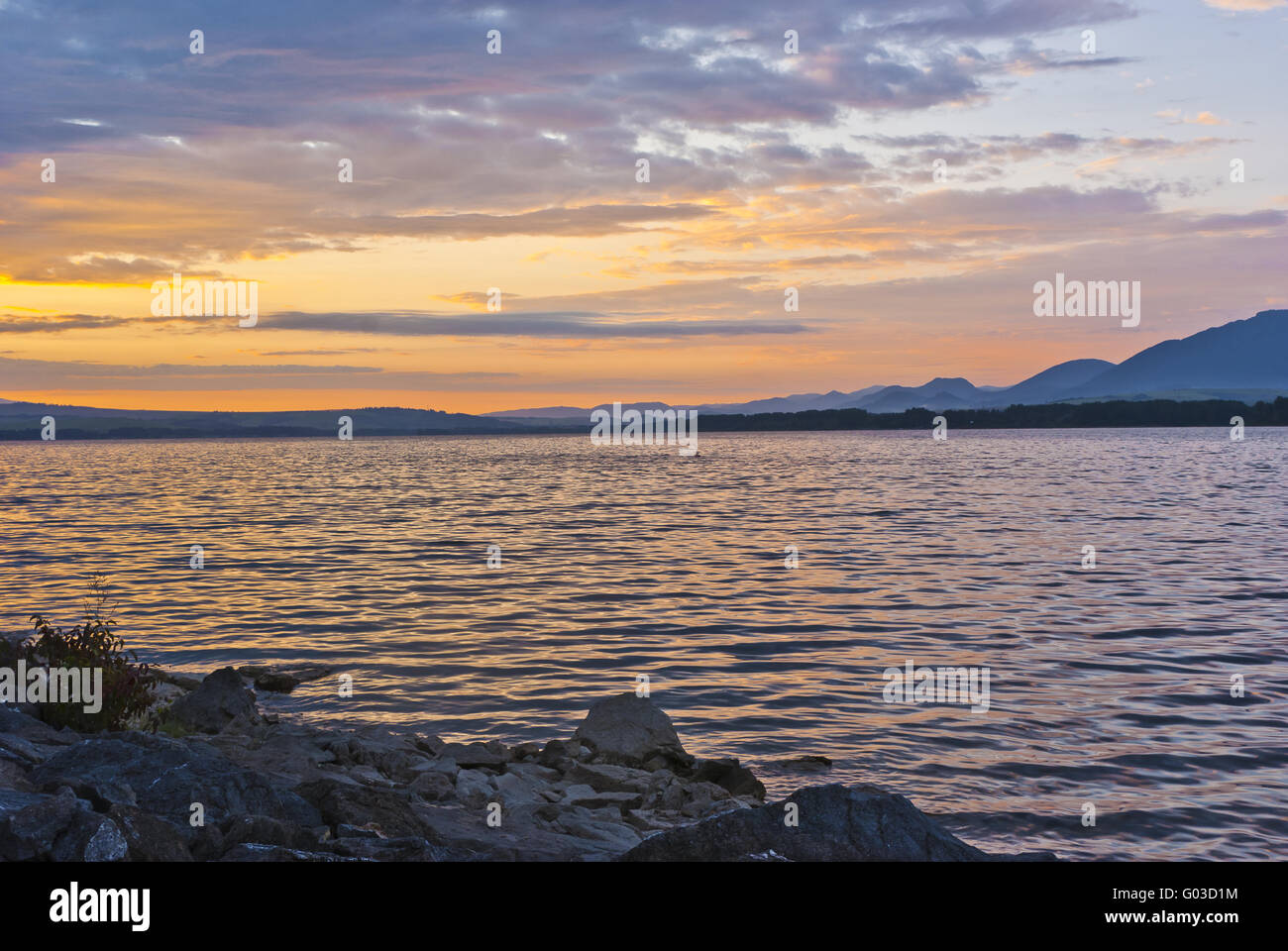 Sun rising over the mountains and lake Stock Photo - Alamy