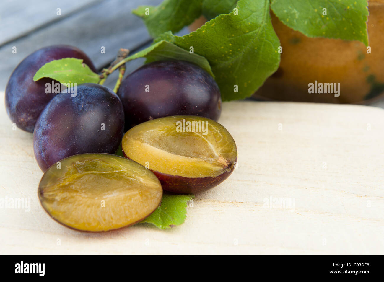 Plums, one is sliced open Stock Photo - Alamy