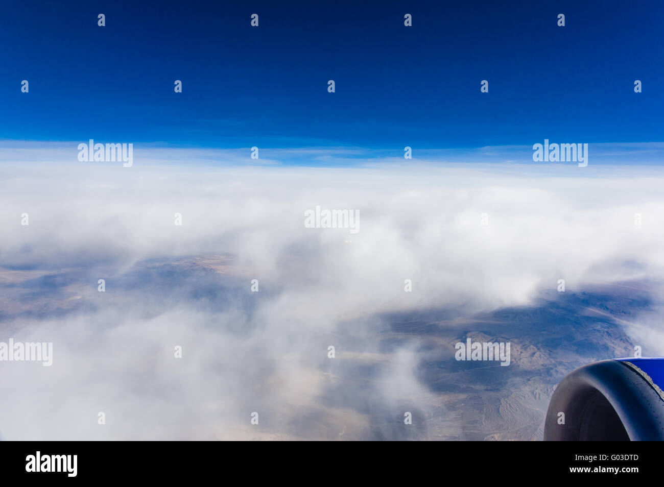 White clouds show off a deep blue sky seen from a passenger jet over ...