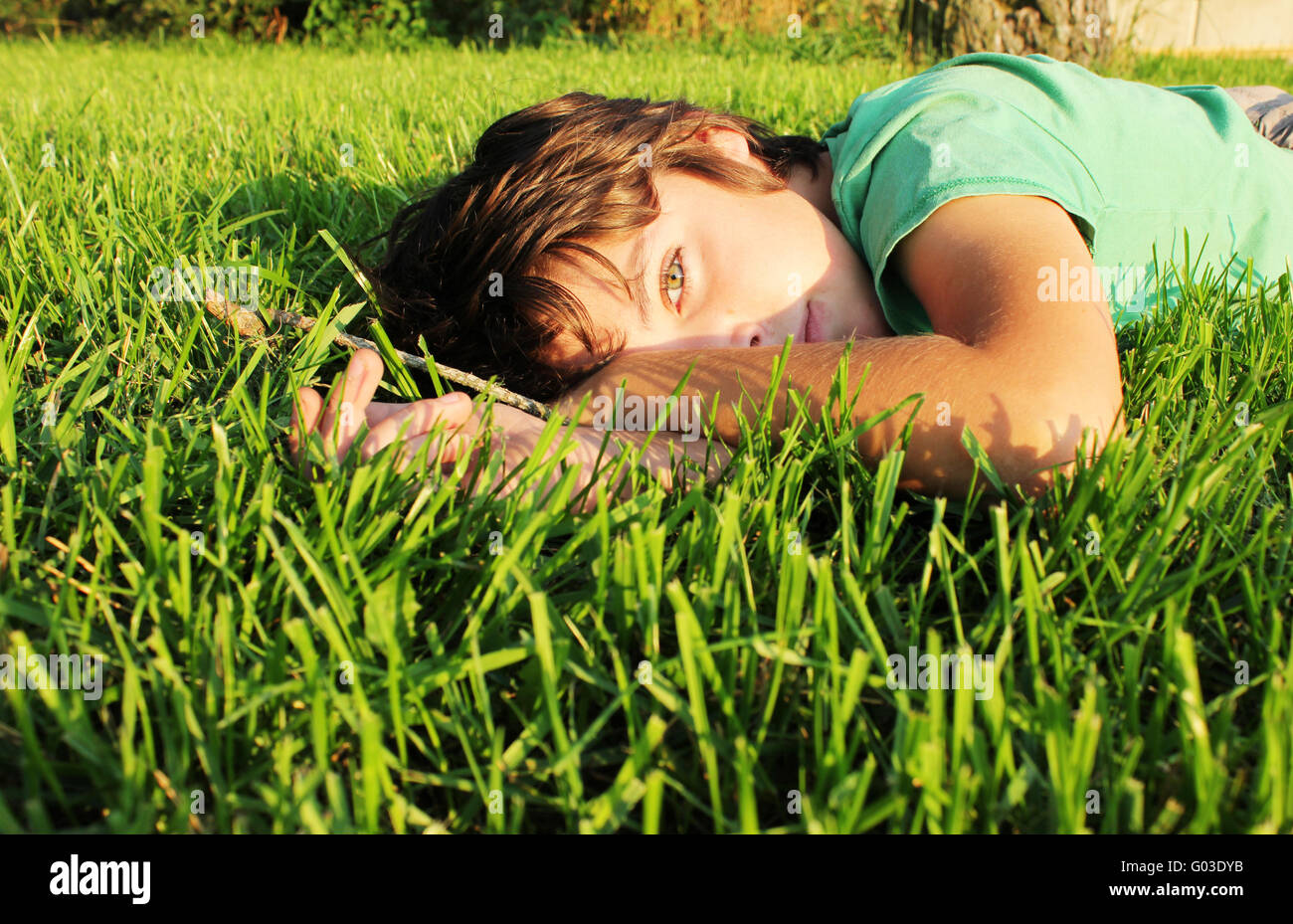 Teen boy laying grass hi-res stock photography and images - Alamy
