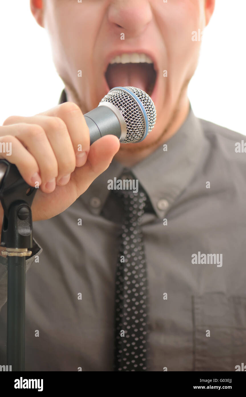 businessman or singer screaming holding microphone with his hand ...