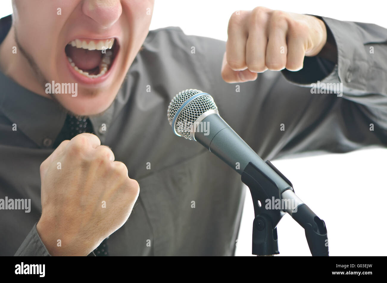 businessman screaming in microphone with his fist rased up isolated on ...
