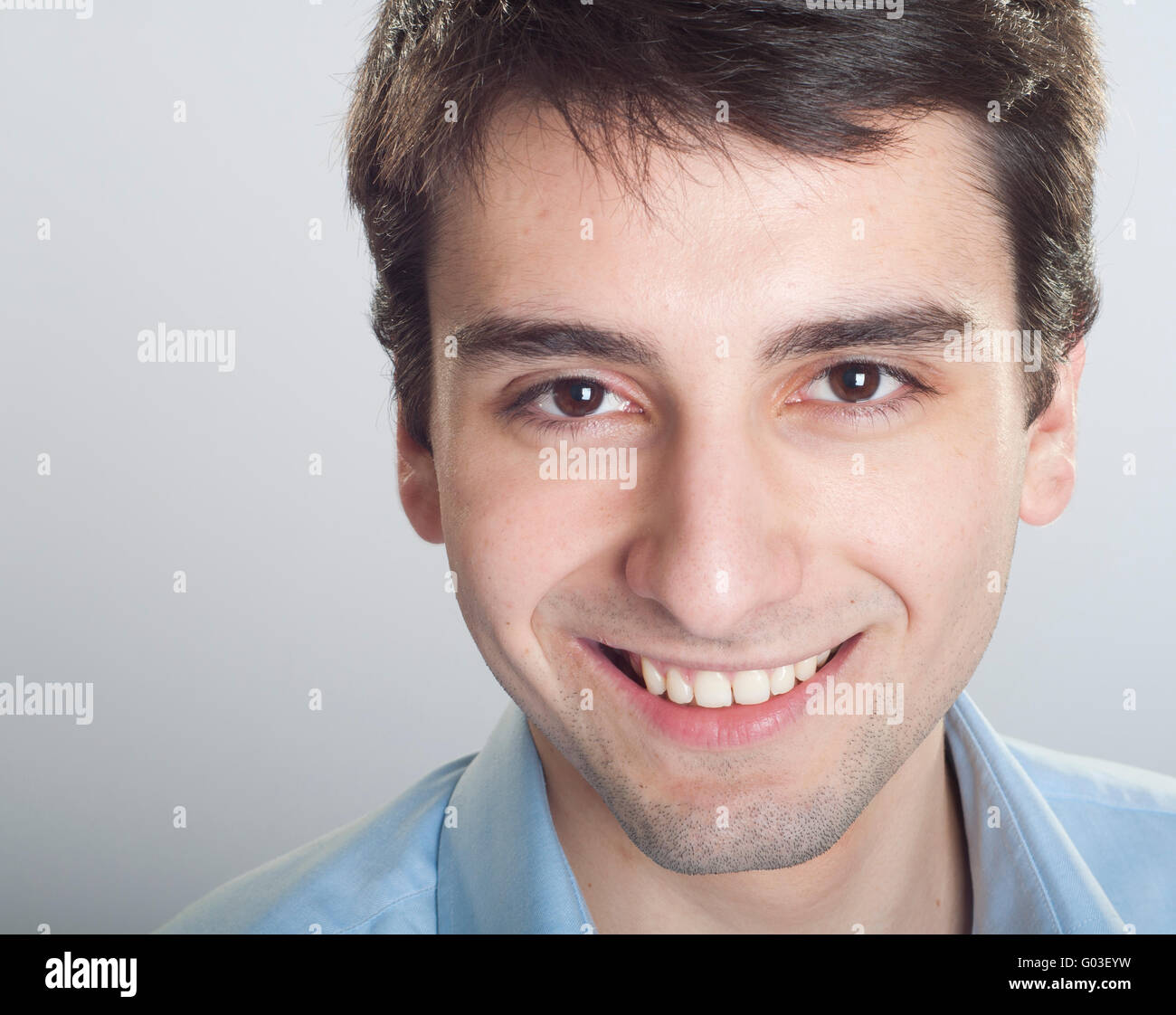 portrait of a smiling handsome trainee starting business career (close ...