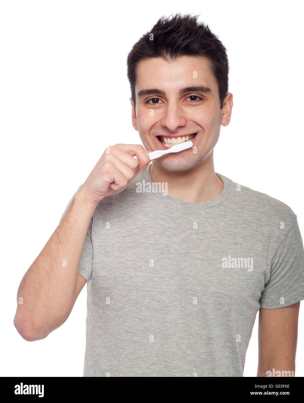 handsome young man brushing his teeth with toothbrush (isolated on ...