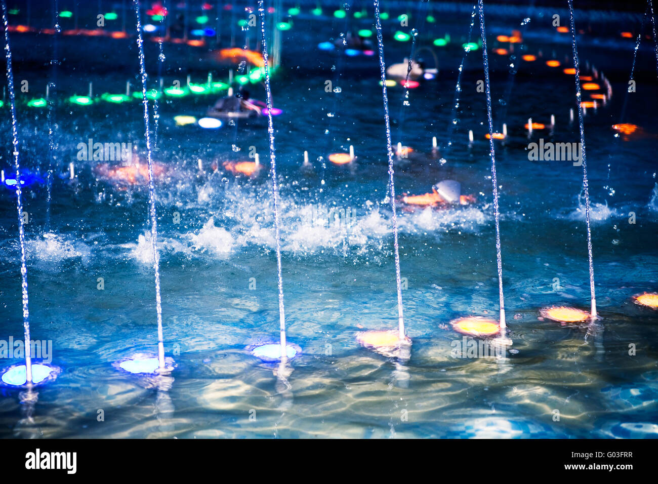 Fountain with multi-coloured illumination in the e Stock Photo - Alamy
