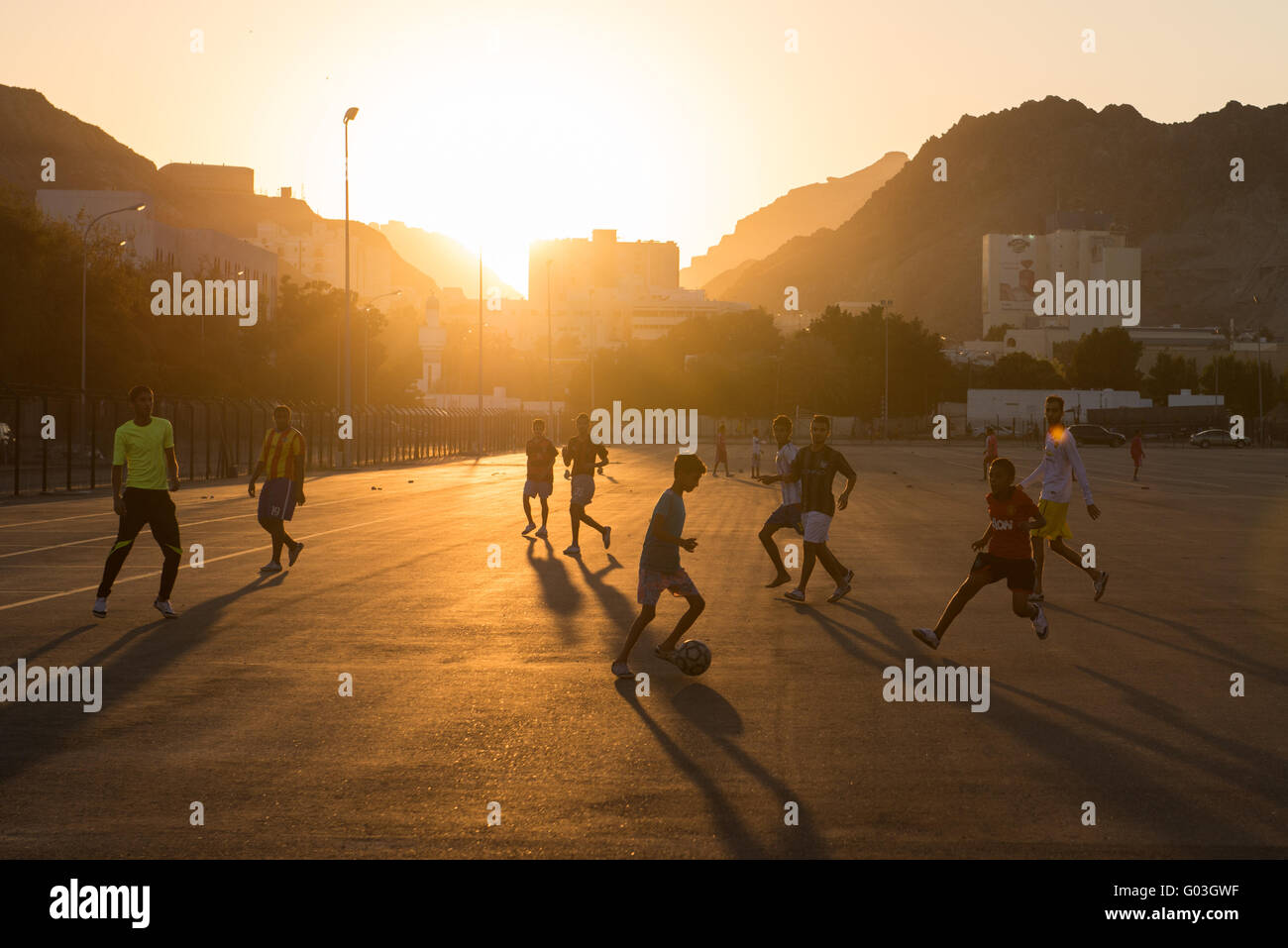 Locals playing football in Muscat, Oman Stock Photo - Alamy