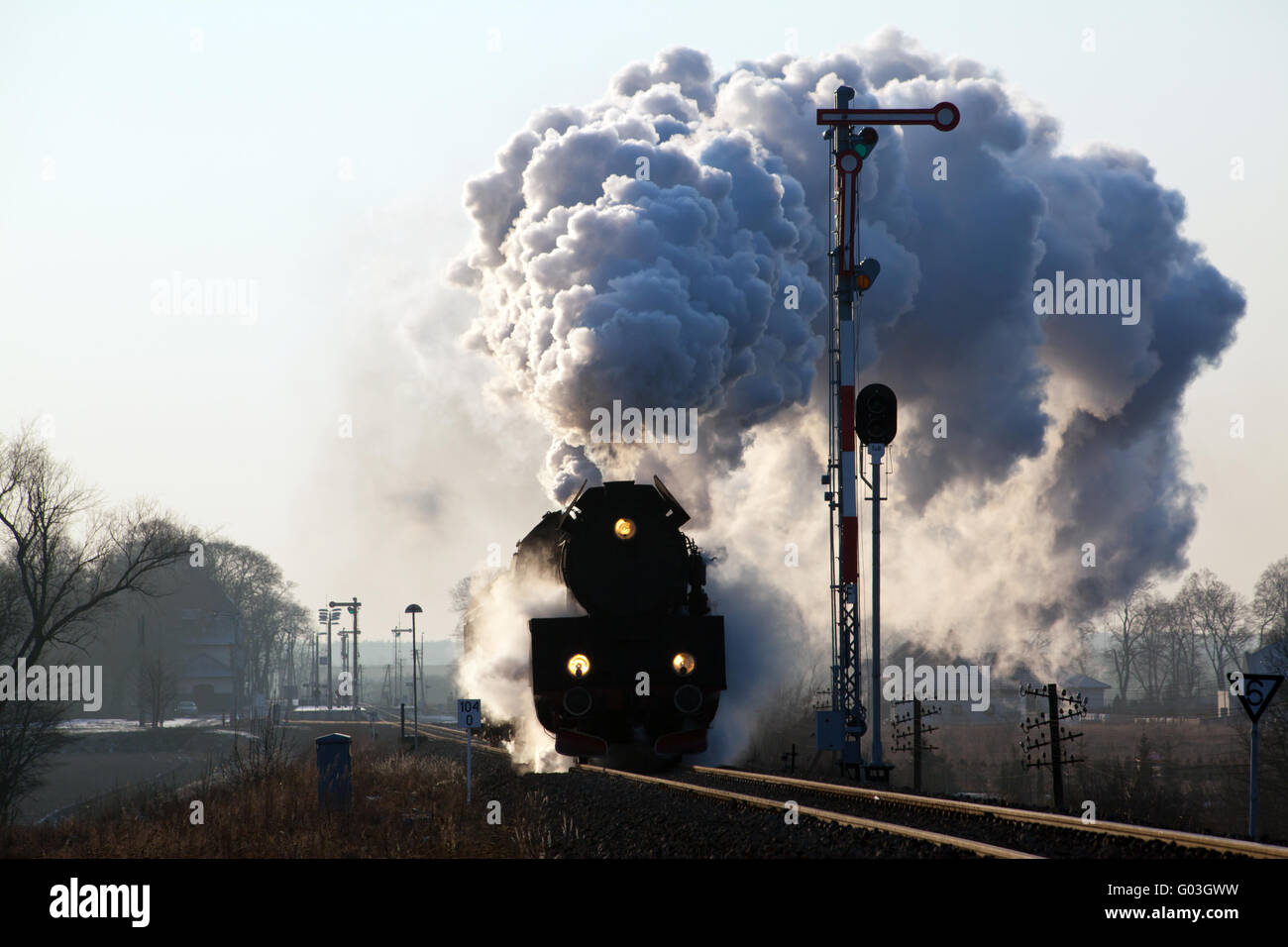 Vintage steam train starting from the station Stock Photo - Alamy