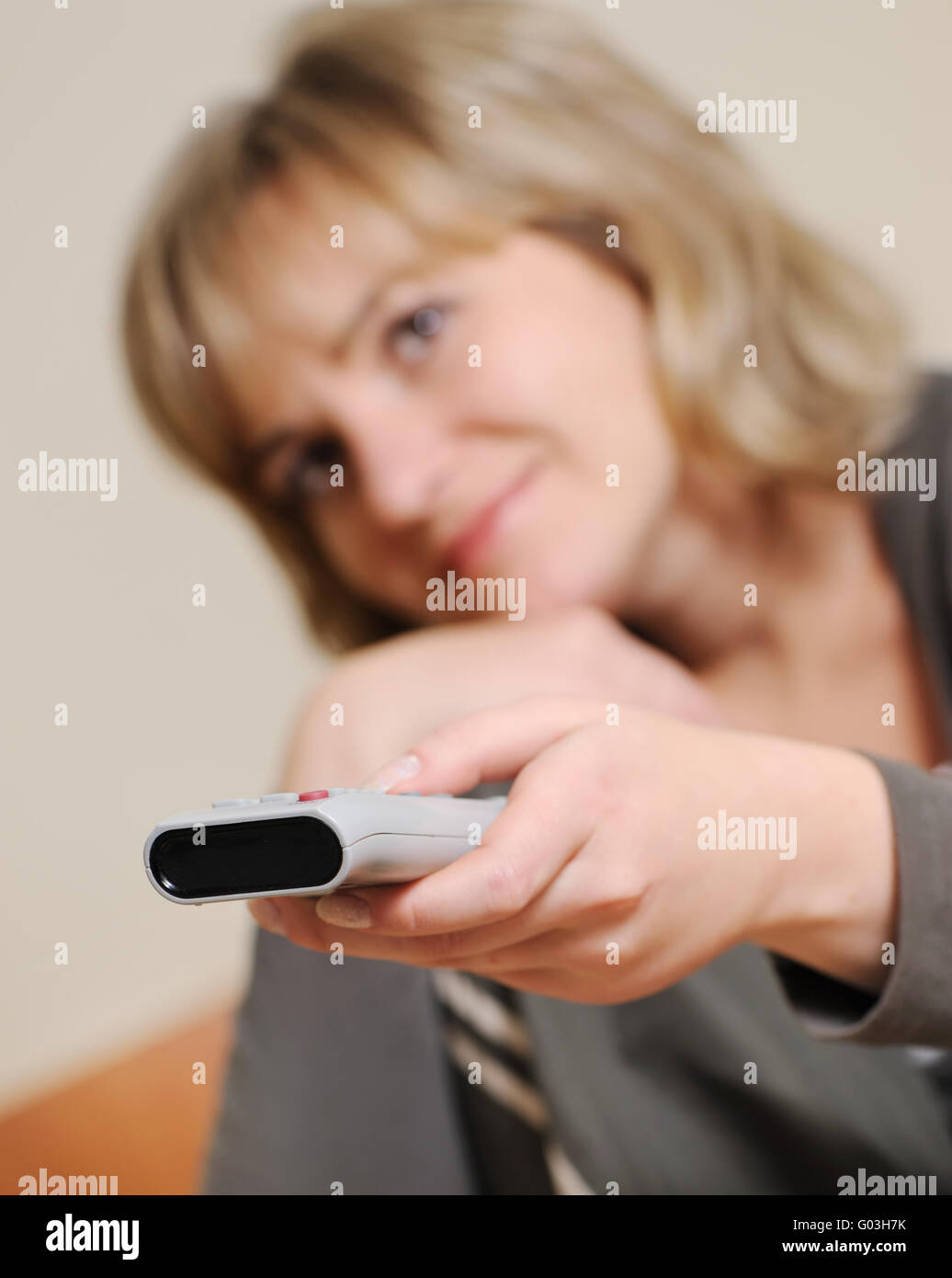 The woman with a television control panel. Selective focus Stock Photo ...
