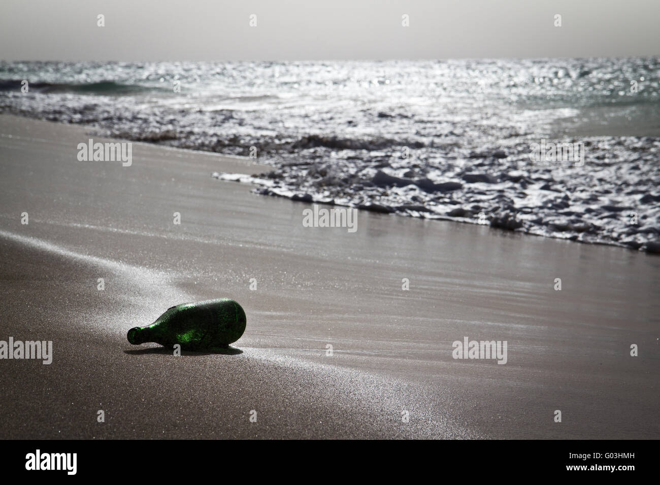 Flotsam and jetsam, a bottle, floating debris, bot Stock Photo - Alamy