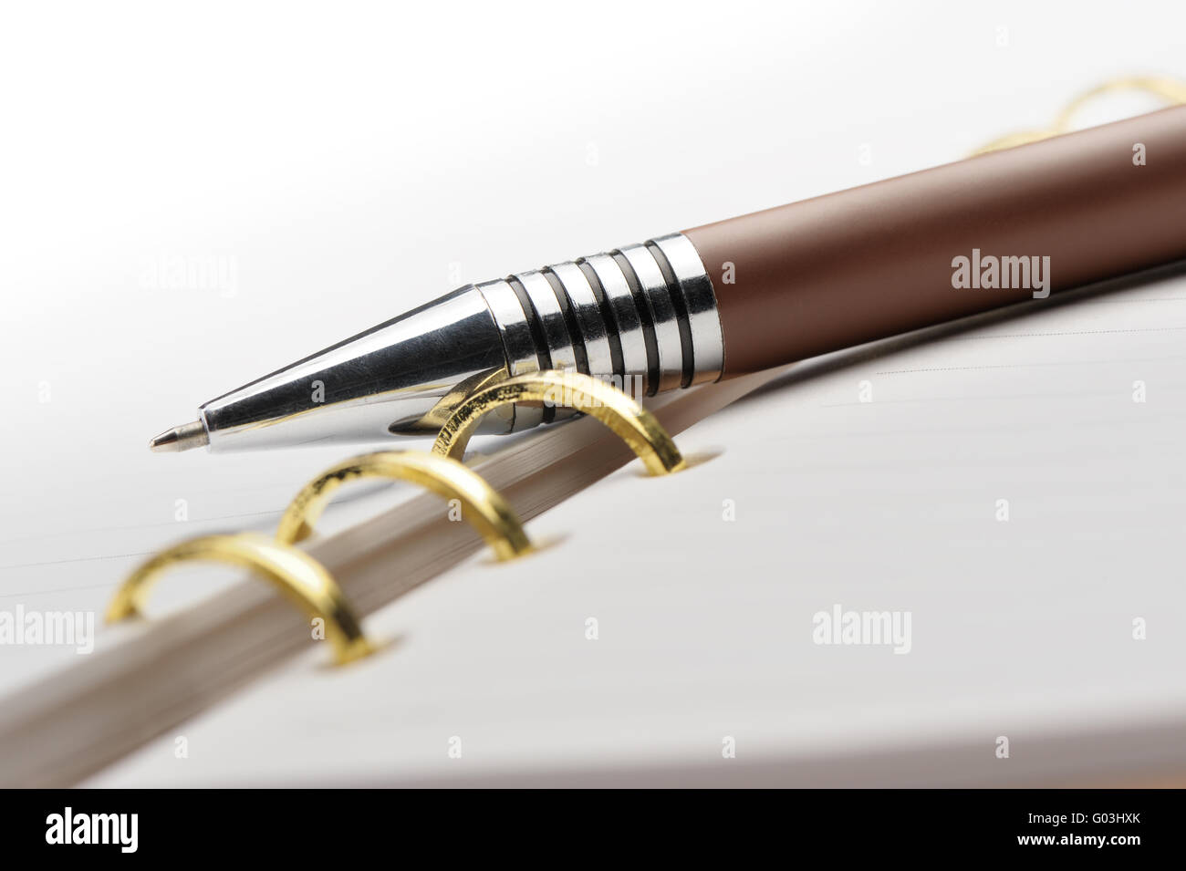 Open notebook with copper binding and stylish pen Stock Photo - Alamy