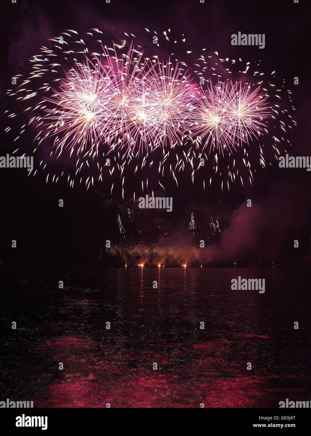 Colorful fireworks with reflection on lake and night sky in background ...