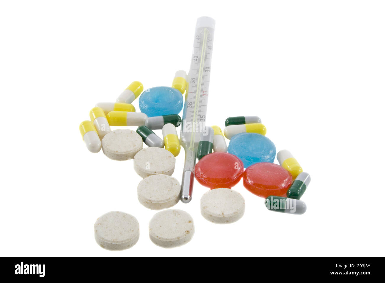 Many different color tablets, pills and thermometer isolated over white ...