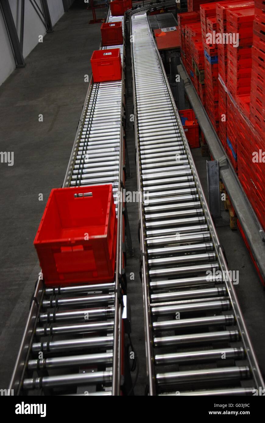 LOGISTICS red boxes on treadmill Stock Photo - Alamy