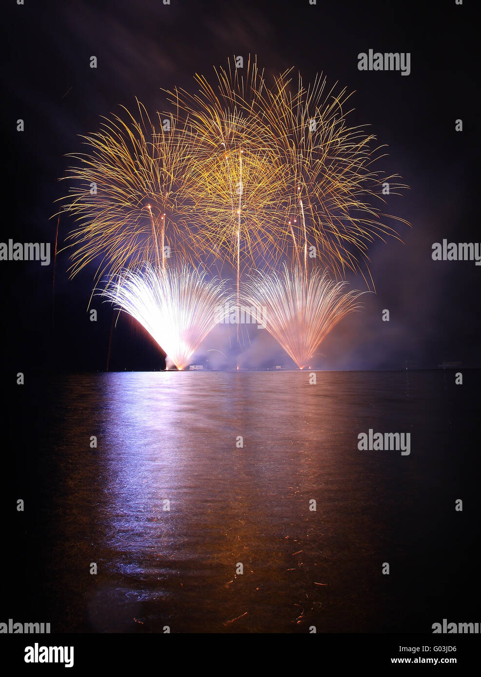 Colorful fireworks with reflection on lake and night sky in background ...