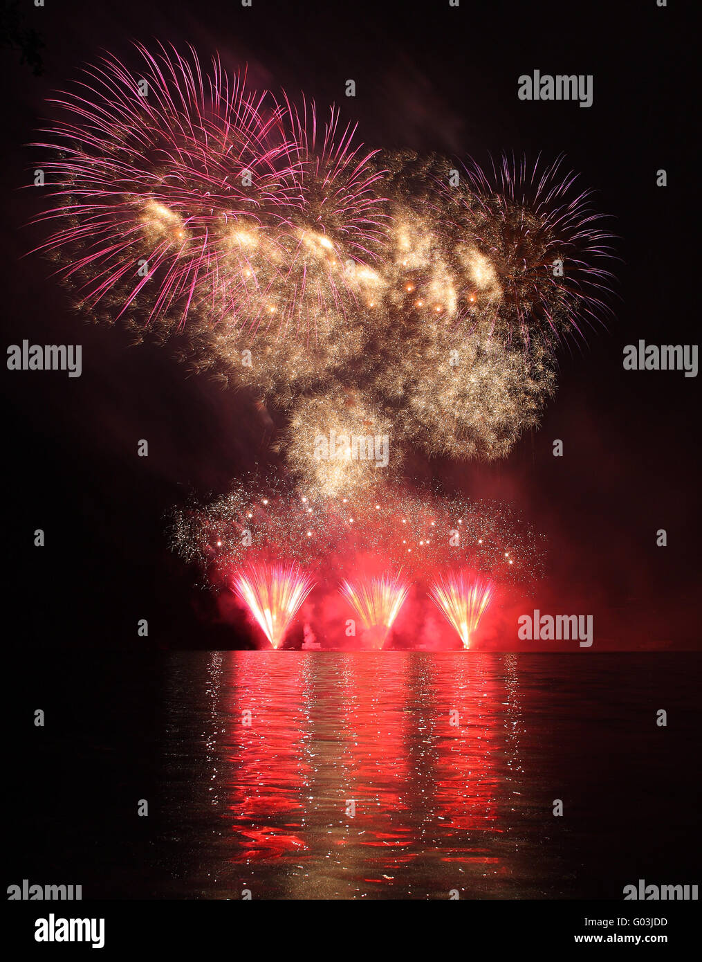 Colorful fireworks with reflection on lake and night sky in background ...