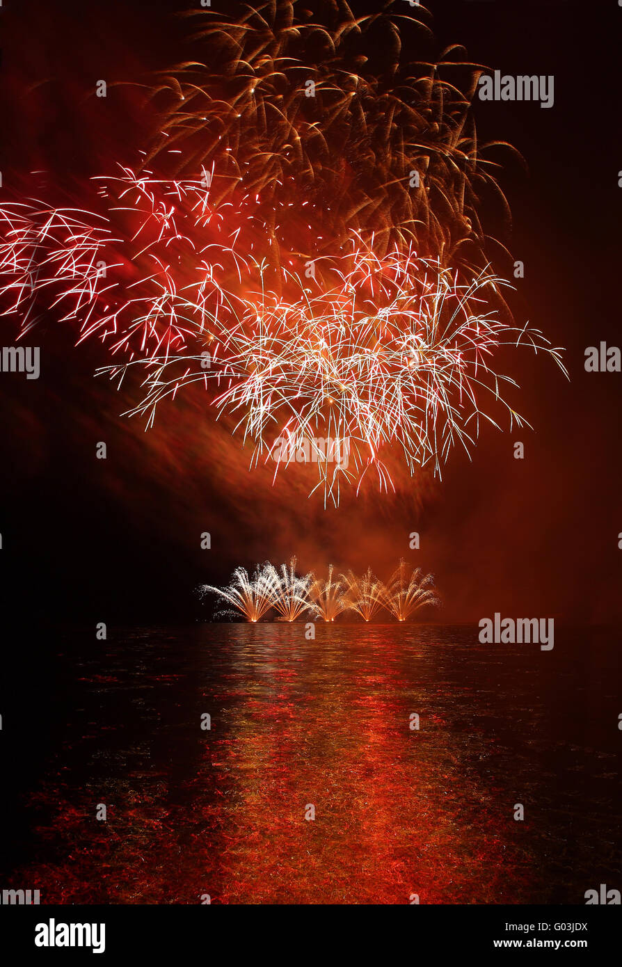 Colorful fireworks with reflection on lake and night sky in background ...