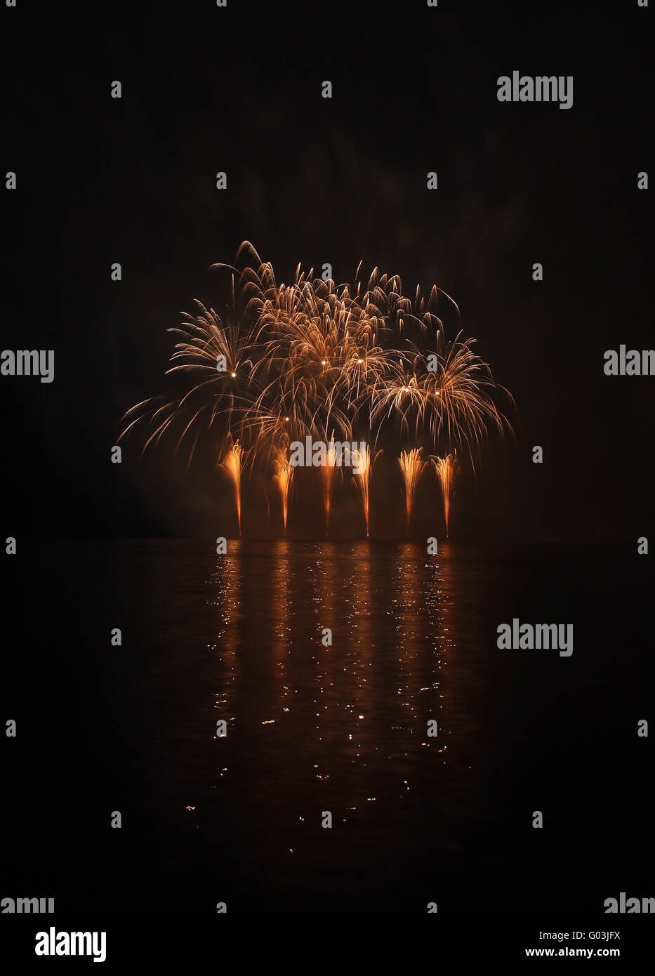 Colorful fireworks with reflection on lake and night sky in background ...