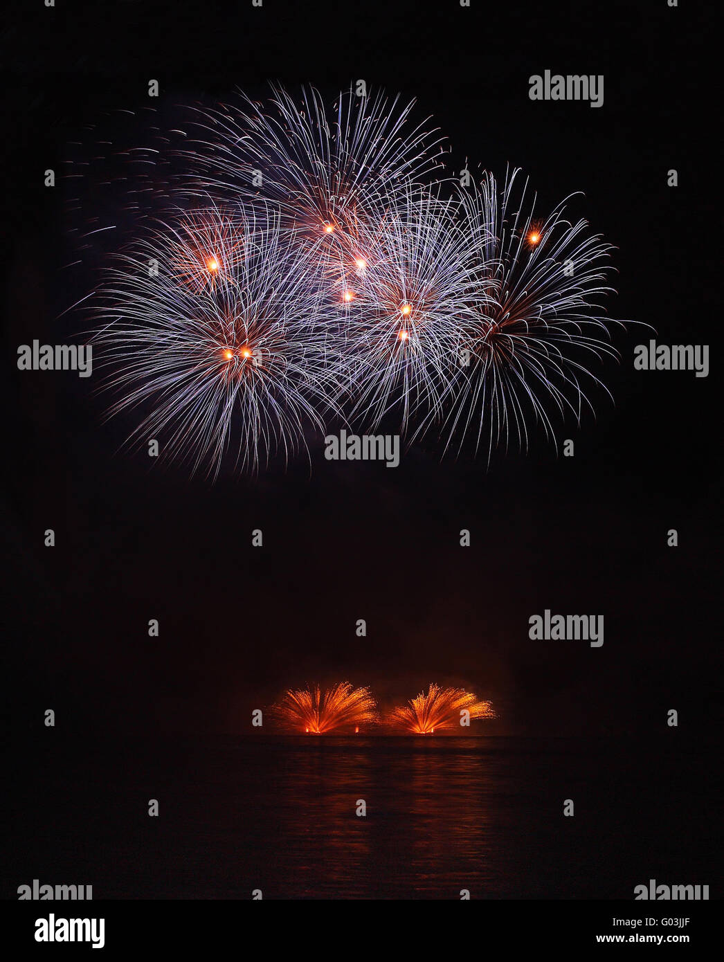 Colorful fireworks with reflection on lake and night sky in background ...