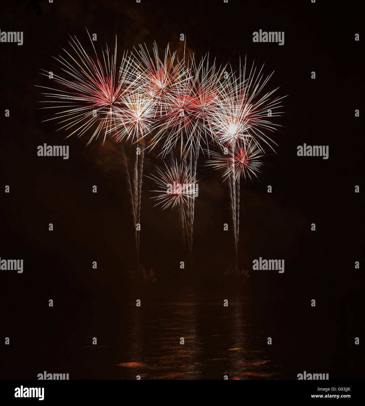 Colorful fireworks with reflection on lake and night sky in background ...