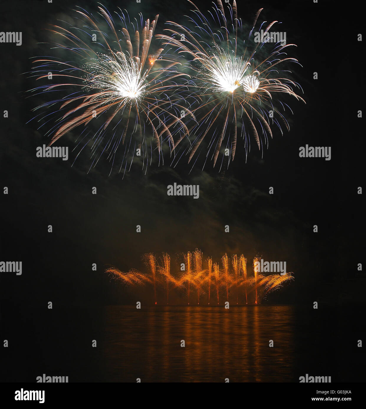Colorful fireworks with reflection on lake and night sky in background ...