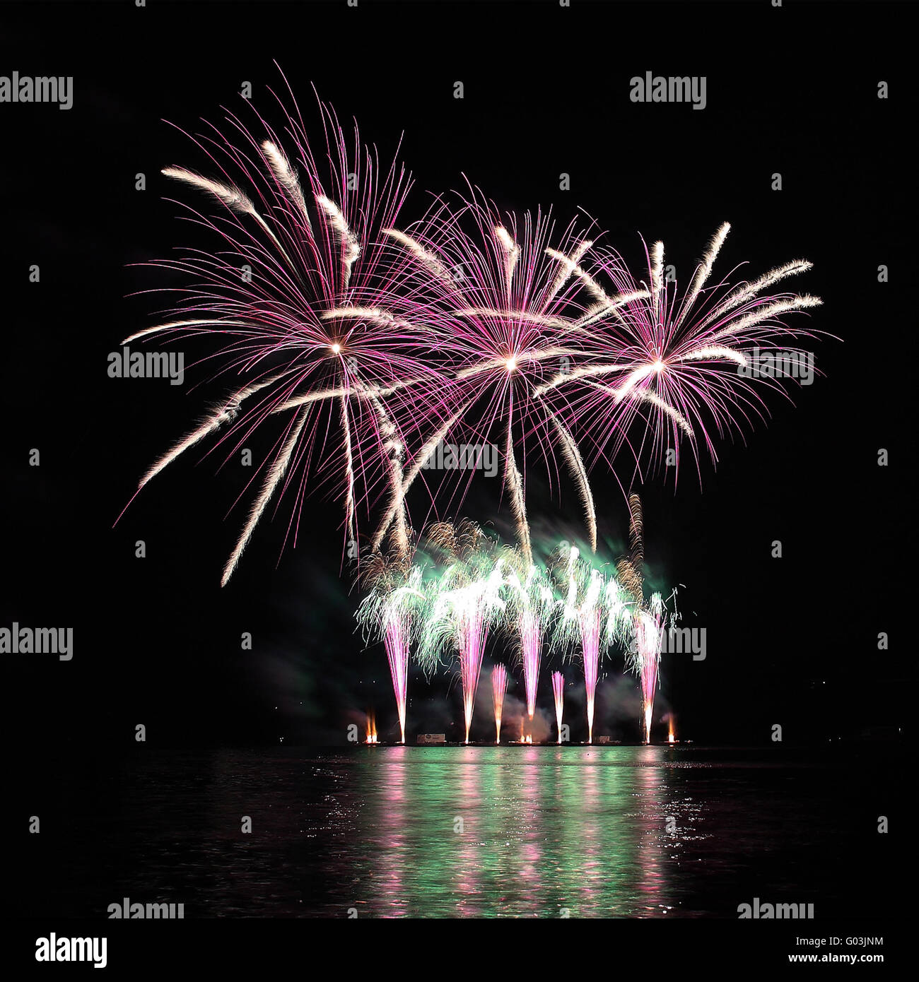 Colorful fireworks with reflection on lake and night sky in background ...