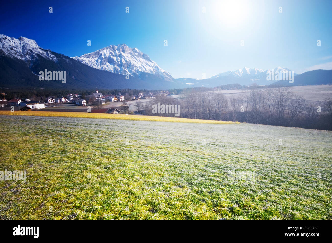Spring Alpine landscape with blue sky and sun Stock Photo - Alamy