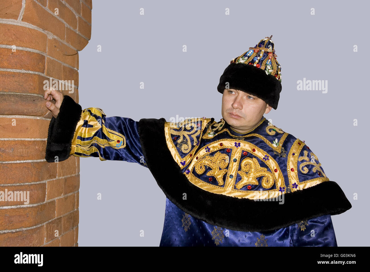 The man in imperial clothes and wall isolated Stock Photo - Alamy