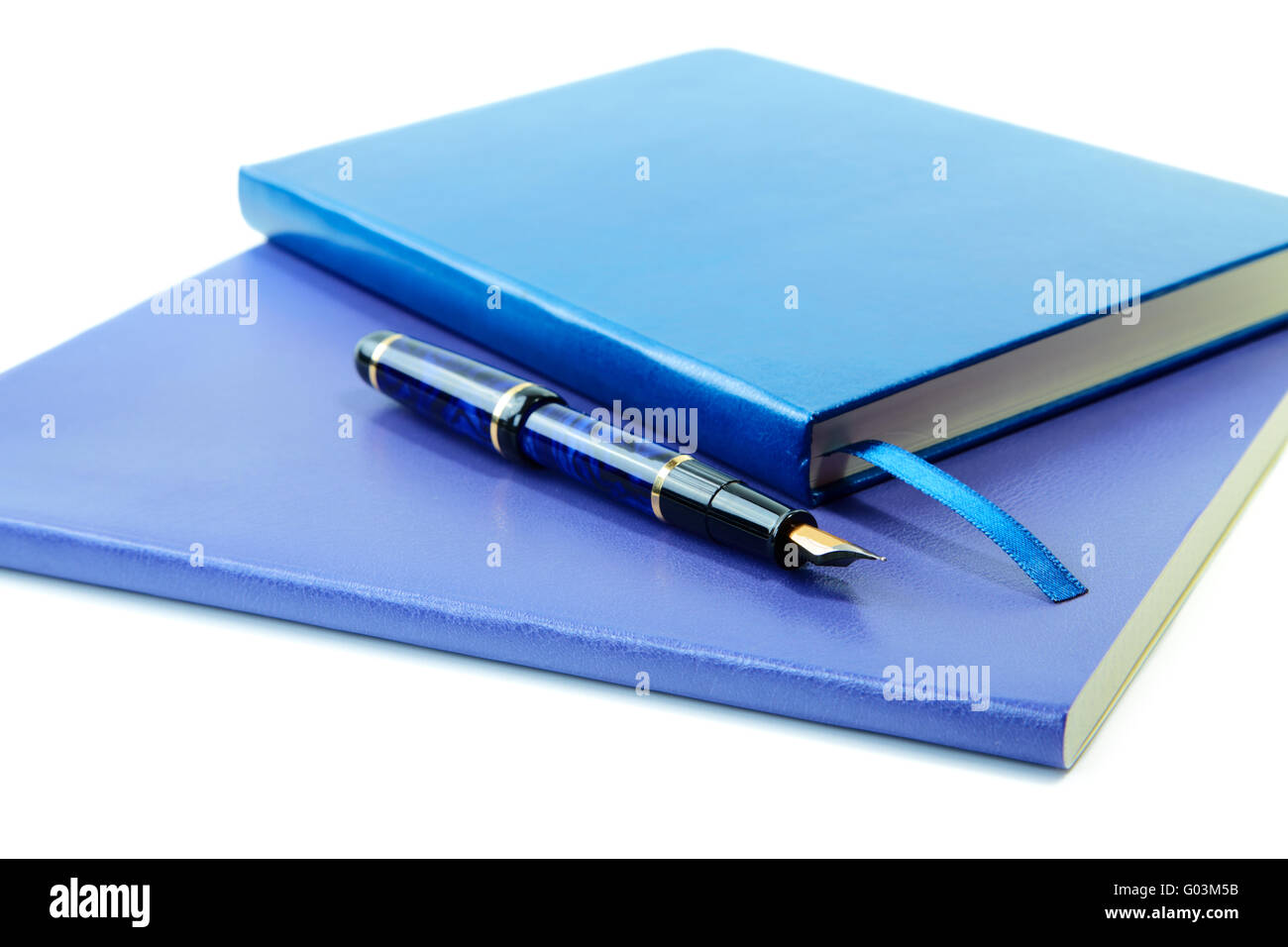 Dark blue writing-books and fountain pen isolated on a white Stock ...