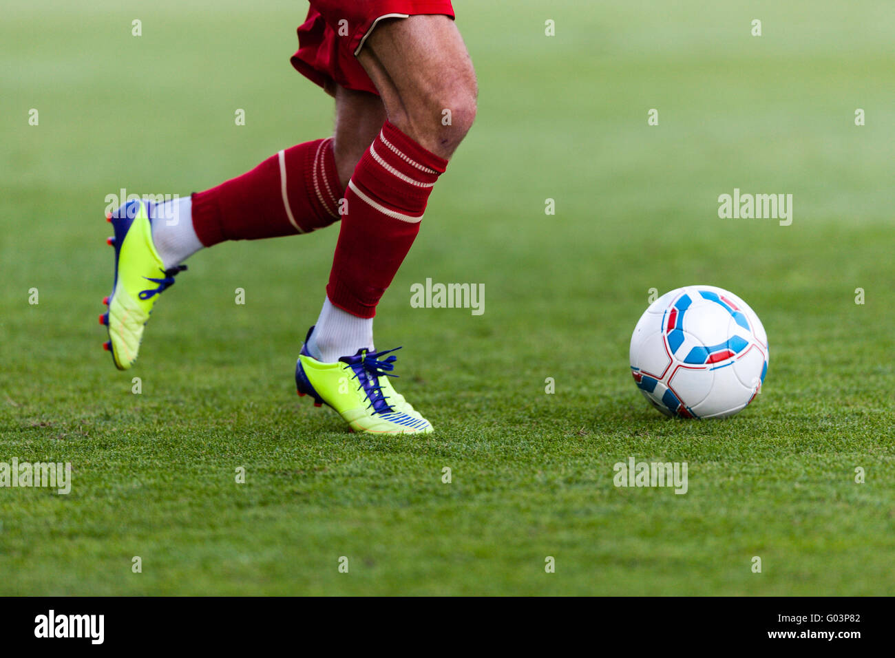 Football player kicks ball Stock Photo - Alamy