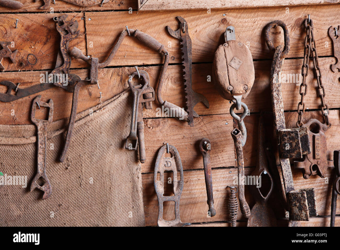 Assorted old work tools on wooden wall Stock Photo - Alamy