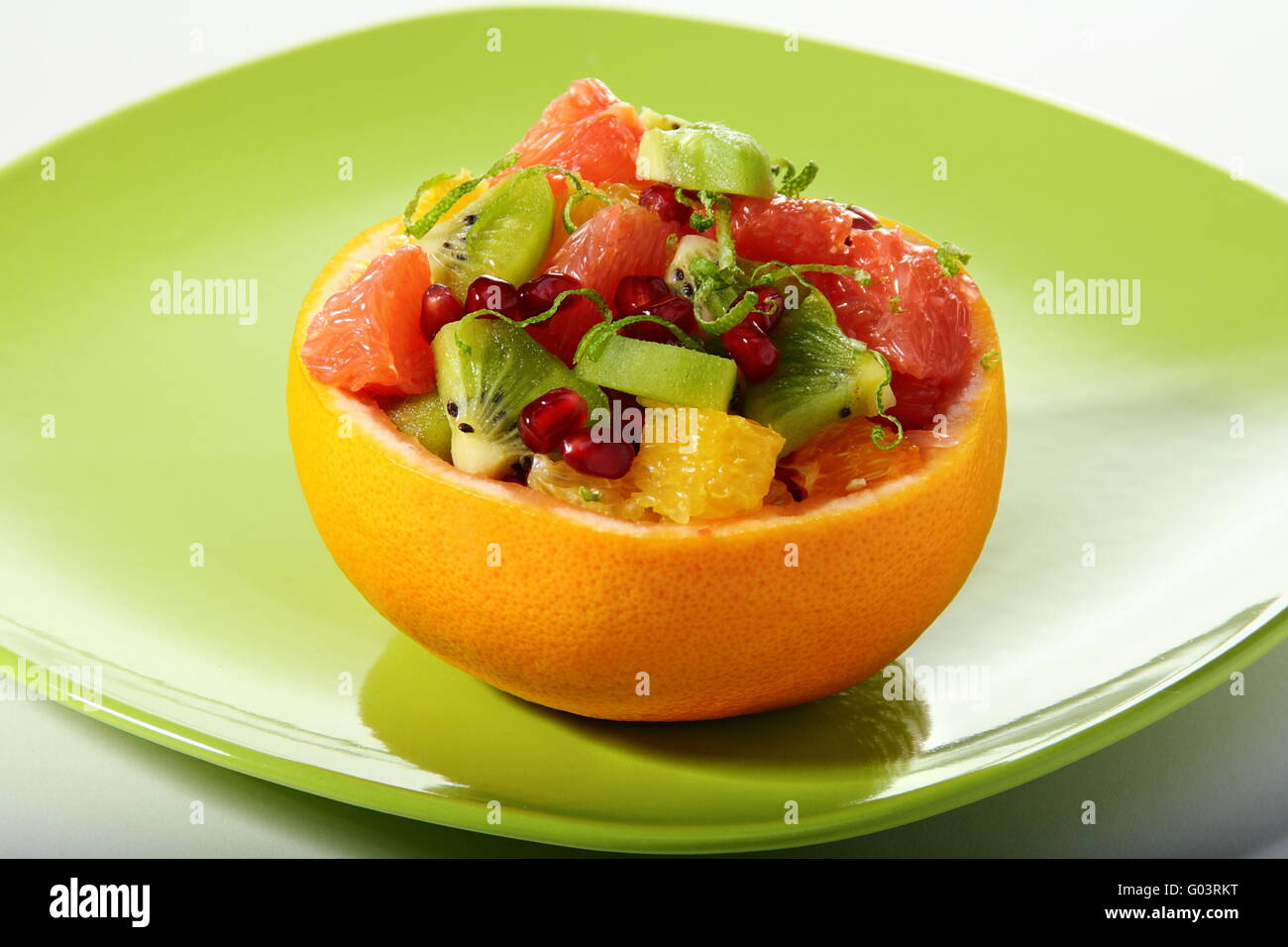 Serving of fresh fruit citrus salad in grapefruit Stock Photo - Alamy