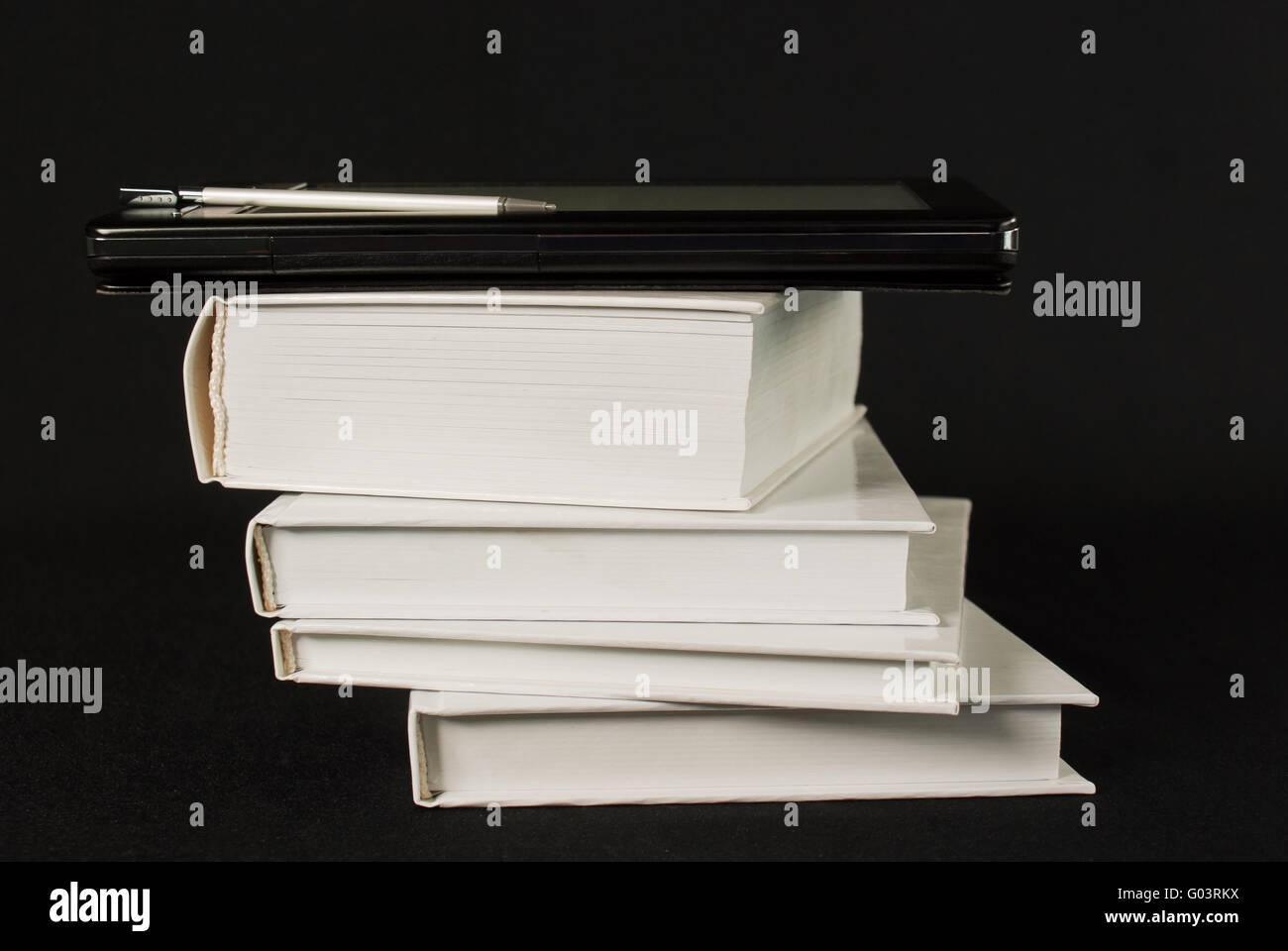 Stack of printed books with electronic book reader Stock Photo - Alamy