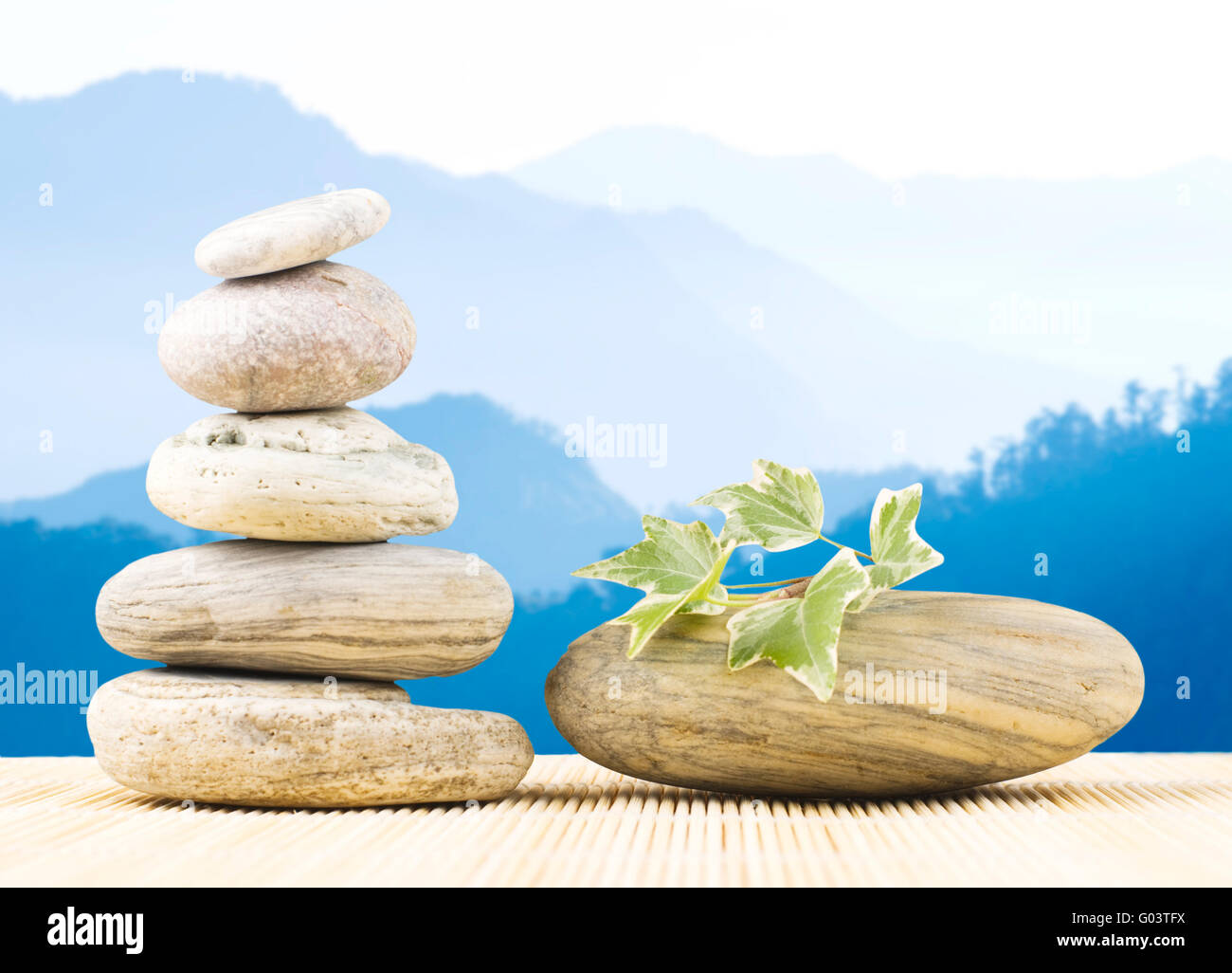 Stack pebbles in front of mountains with light morning fog Stock Photo ...