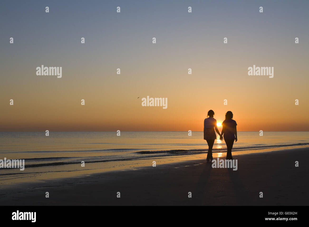 Friends at sunset Stock Photo - Alamy