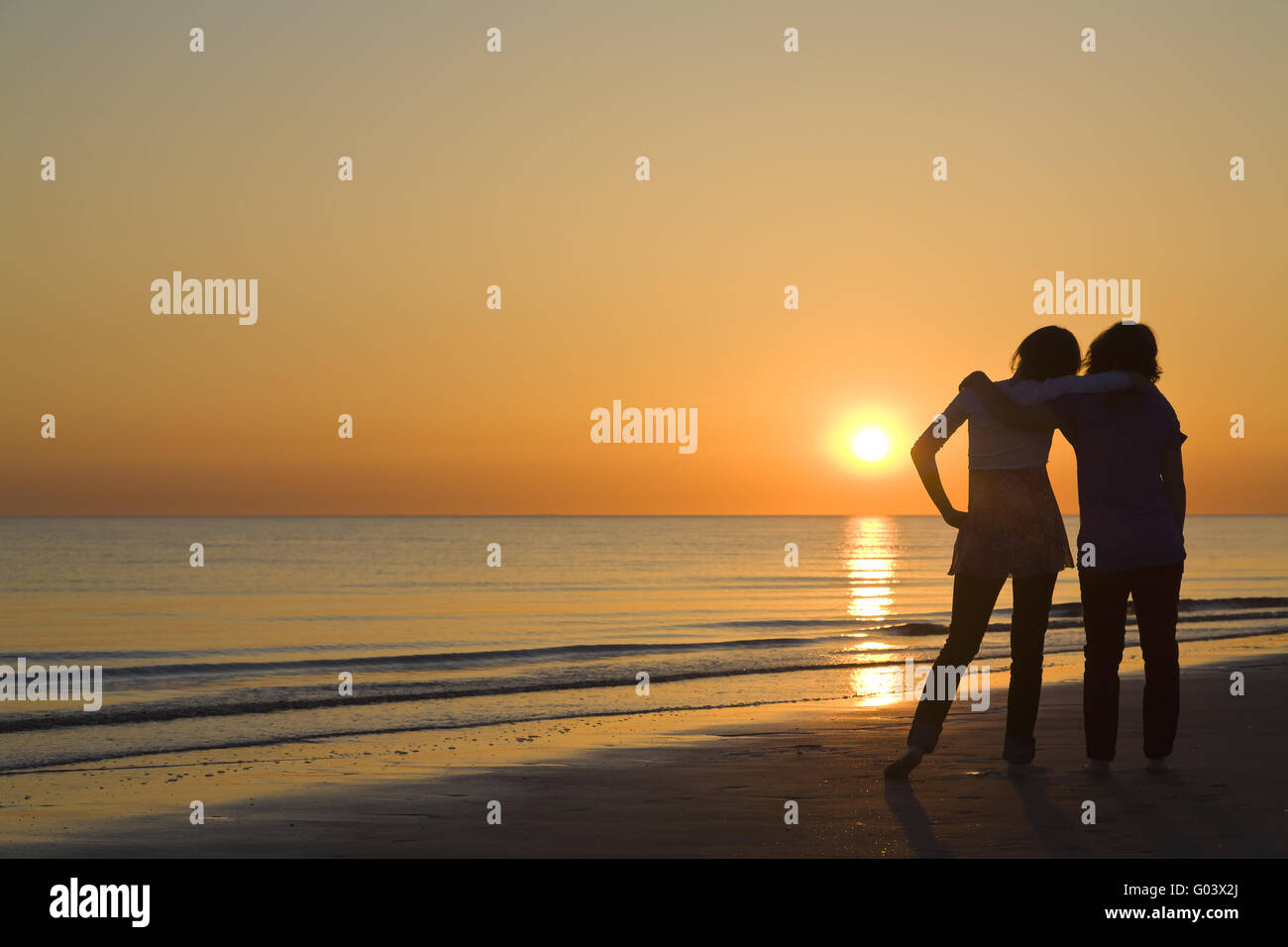 Friends at sunset Stock Photo - Alamy
