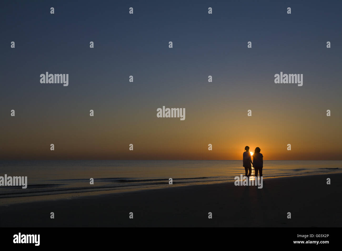 Friends at sunset Stock Photo - Alamy