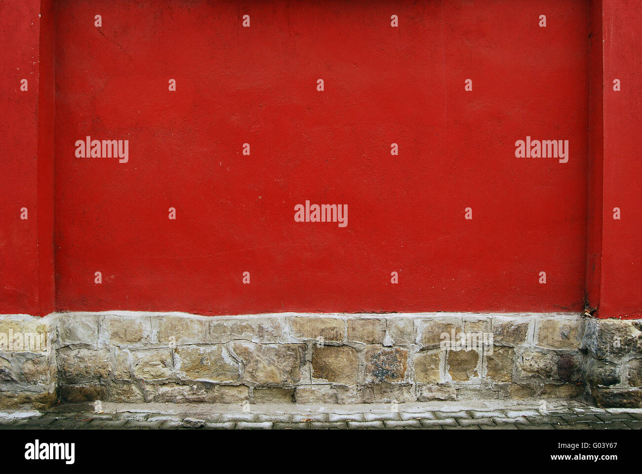 Red plastered house wall and stone base Stock Photo - Alamy