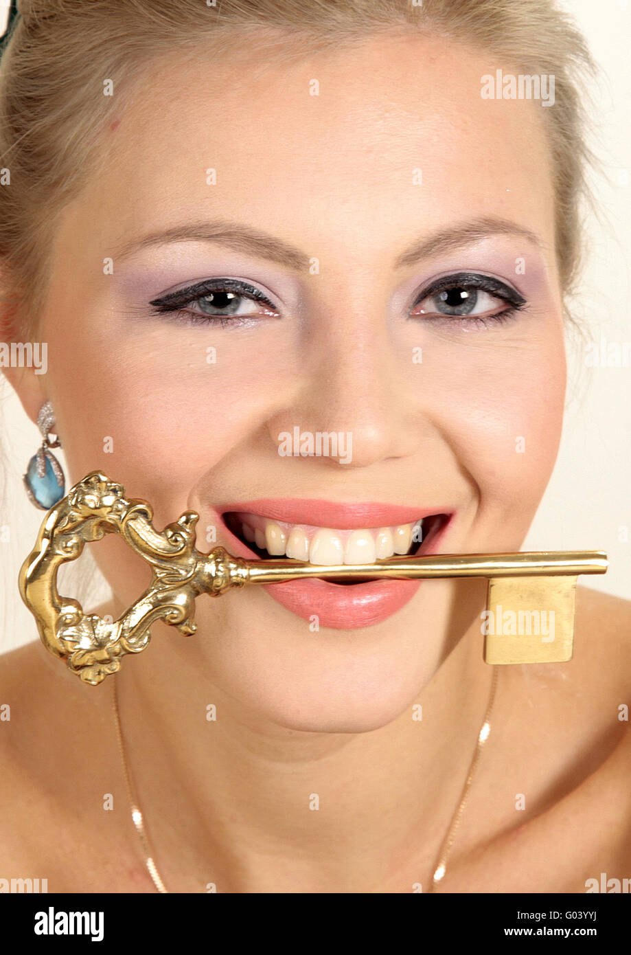 Woman with key Stock Photo - Alamy