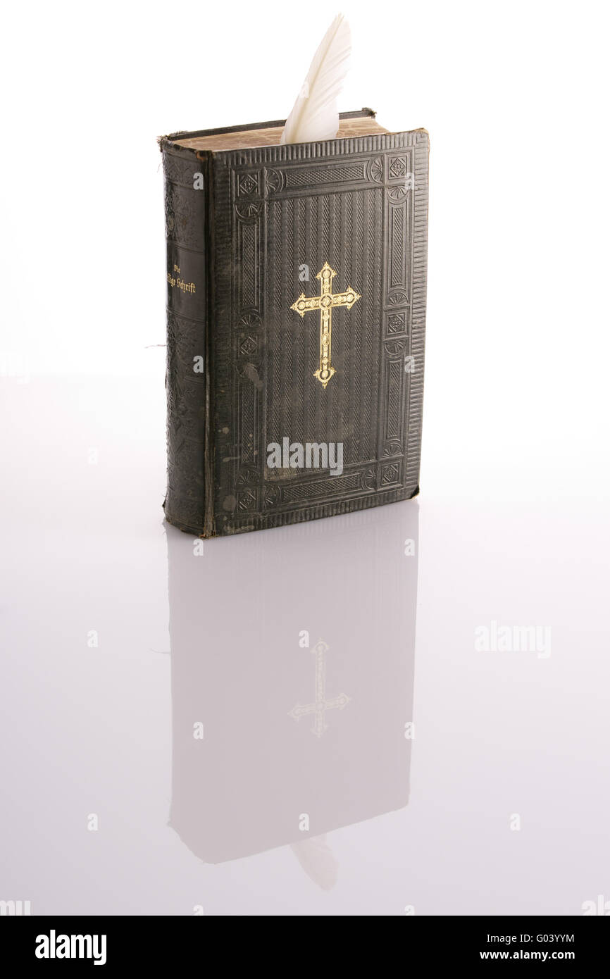 Holy book - bible - with feather Stock Photo - Alamy