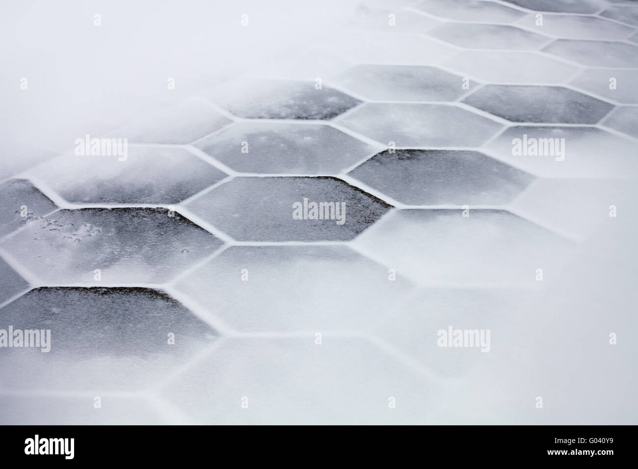 Hexagonal tiles covered with snow Stock Photo - Alamy