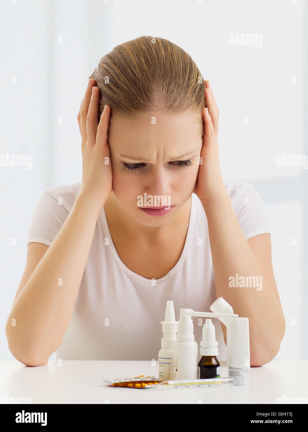 woman with a headache and flu and with medicines Stock Photo - Alamy