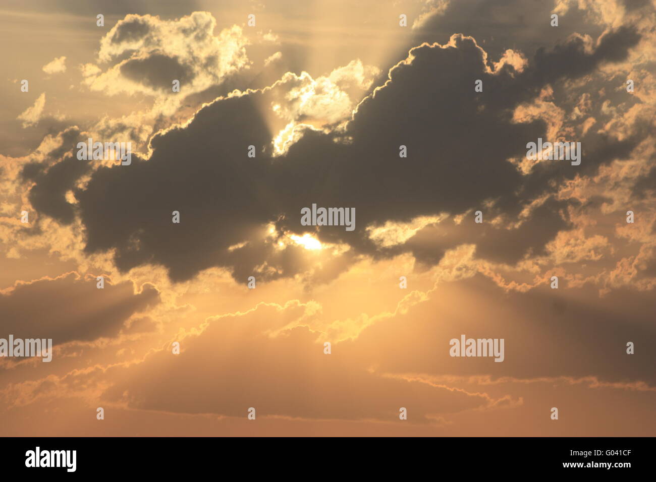 Hidden Sun Sunset behind the cloud's Stock Photo - Alamy
