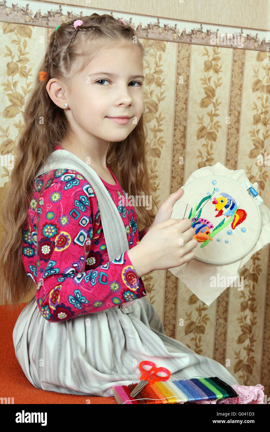 Girl with a home-made embroidery in the hands of Stock Photo - Alamy