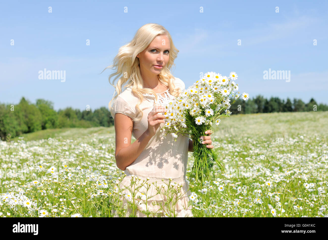 beautiful young woman at the meadow with bunch of chamomiles Stock ...