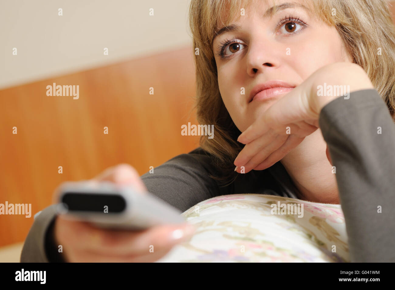 The woman with a television control panel. Selective focus Stock Photo ...
