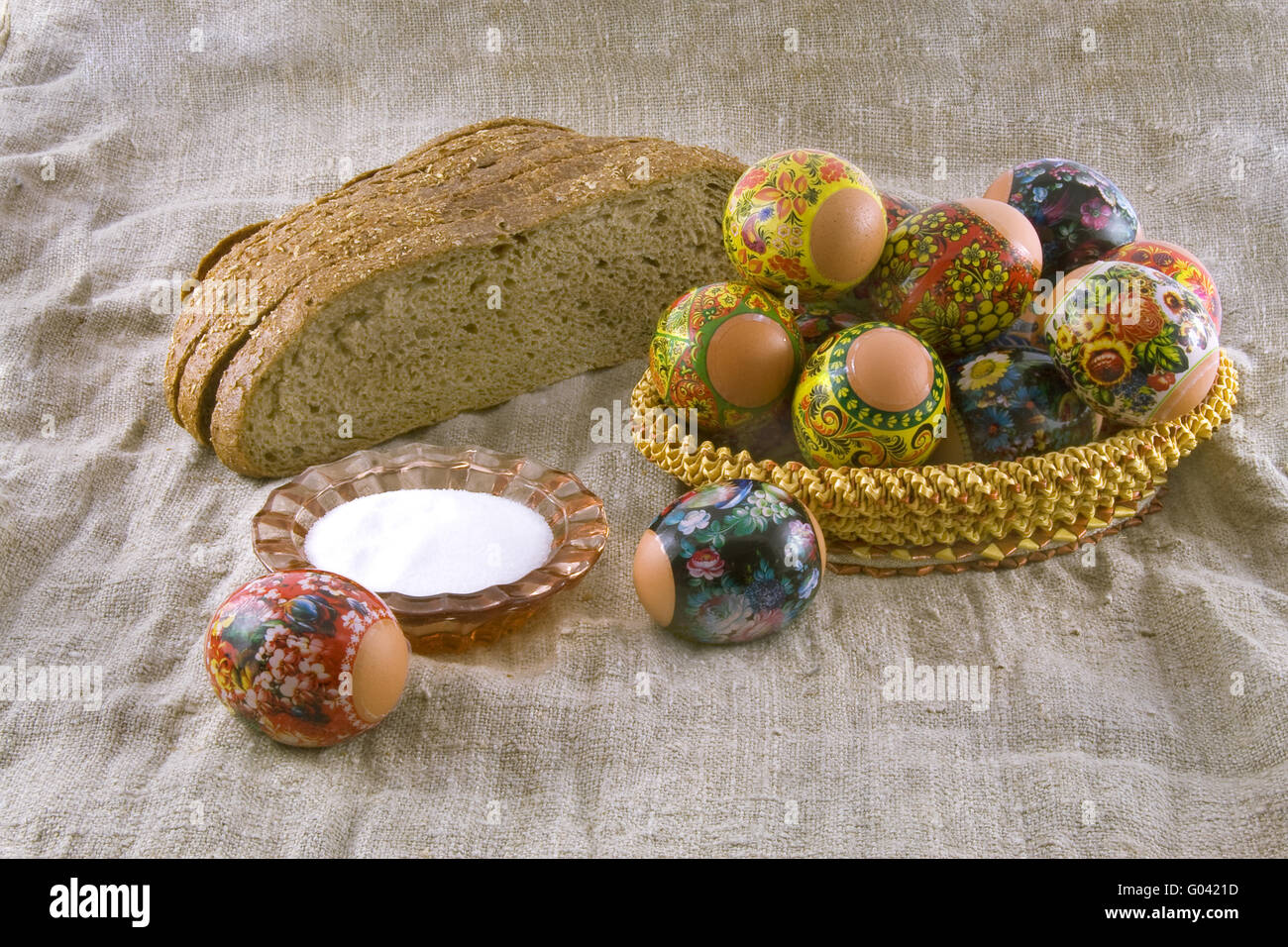 Many fresh easter rural decorated eggs lying in a wattled small basket ...