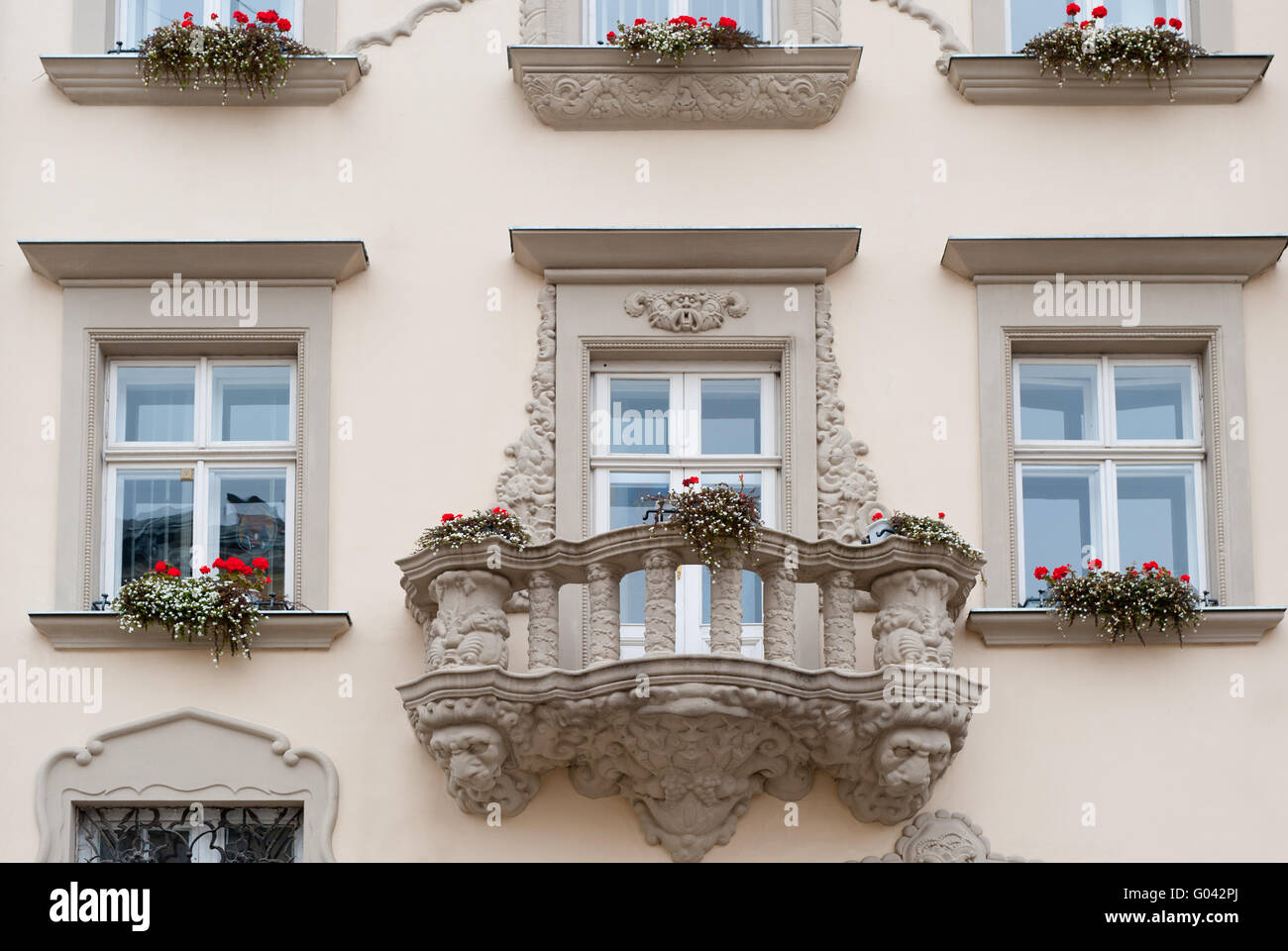 Facade of a building with a balcony and flowers Stock Photo - Alamy
