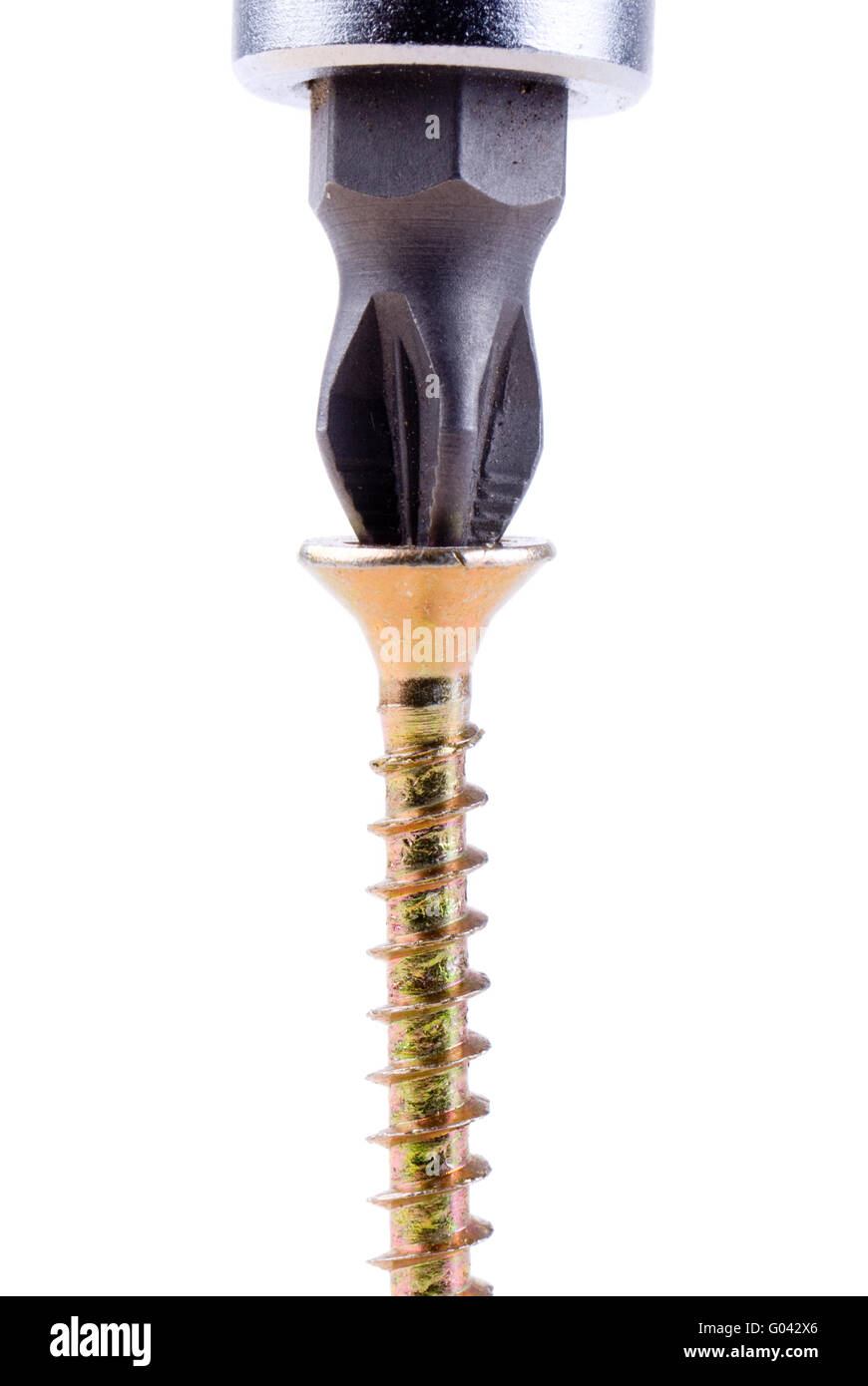 Closeup image of screwdriver and single screw in board on white ...