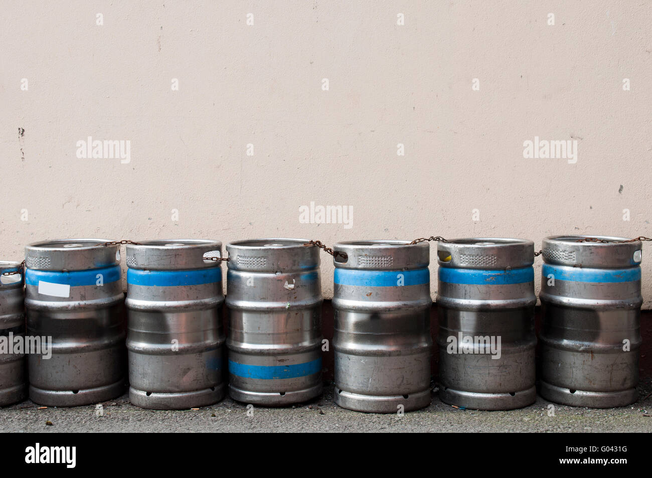 row of beer kegs against a light pink wall (copy-space available Stock ...