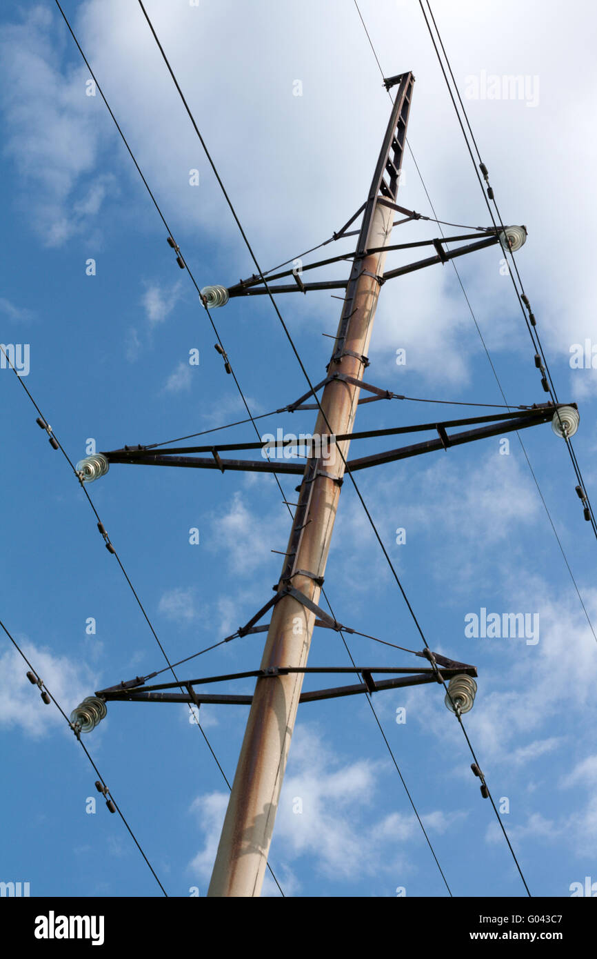 Pole high-tension wire on background blue sky Stock Photo - Alamy